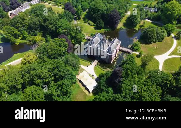 Aerial view of a historic castle surrounded by a forest, with vast ...
