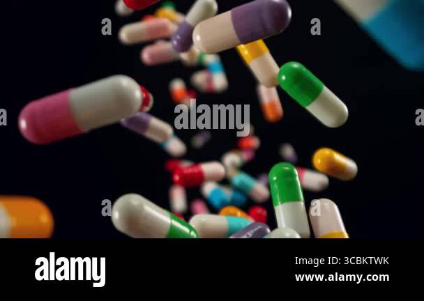 Super Slow Motion of Falling Colorful Pills on Black Background at ...