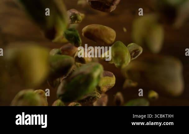 Super Slow Motion Shot of Peeled Pistachio Nuts Falling Around Camera ...