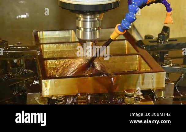 The CNC milling machine rough cutting the vacuum mold parts with oil ...