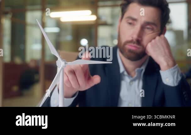 Upset frustrated Caucasian business man looking windmill thinking ...