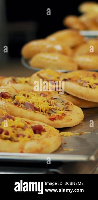 Close-up, showcase with mini pizza, yeast dough baking in modern ...