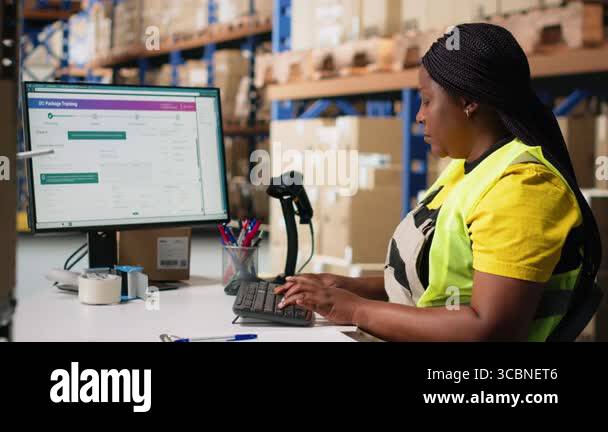 Black employee scanning awb tags after packaging operations in a ...