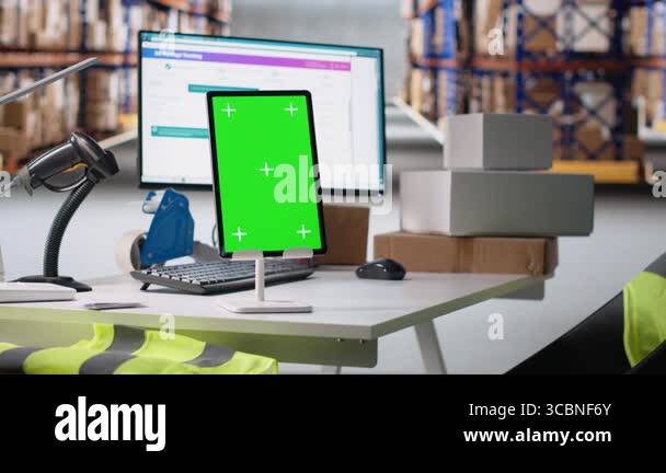 Empty storehouse space shows green screen on computer monitor, handling ...