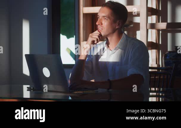 Thinking man planning project at desk. Young businessman sitting at ...