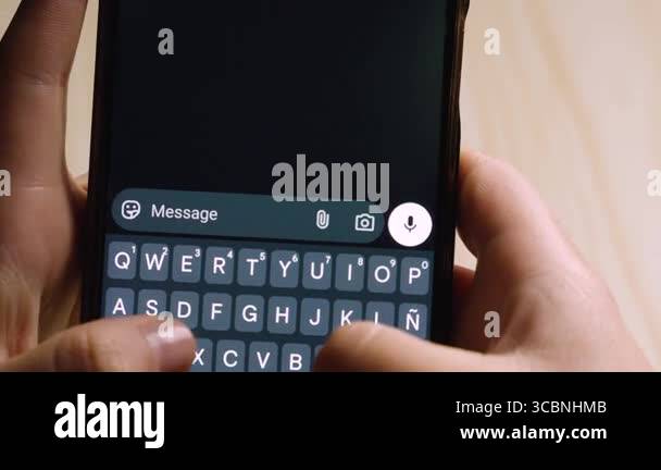 Close-up of fingers typing the XD emoticon, symbolizing laughter, on a ...