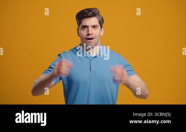 Surprised mature man making mind blown gesture on yellow, idea eureka moment on yellow studio ...