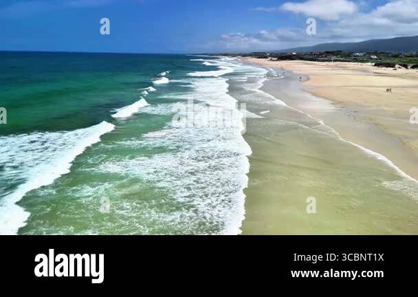 Breathtaking aerial shots depict waves gently lapping the beautiful ...