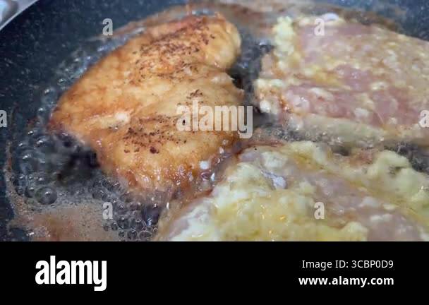 Juicy meat cutlets frying in bubbling oil inside a hot pan. Close-up ...