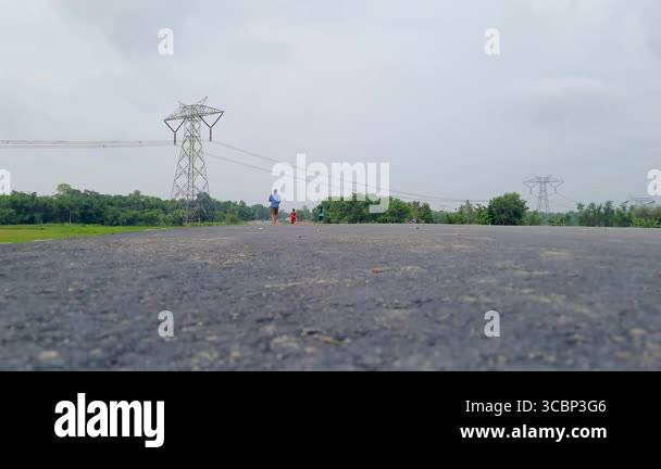 isolated countryside road with running village children and youth at ...