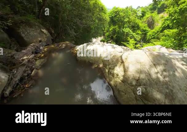 Drone Rapidly Descending Over Jungle Waterfall Toward Rocky Riverbed ...