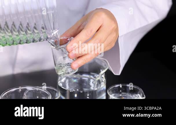 Scientist conducts experiment with beakers and chemicals Stock Video ...