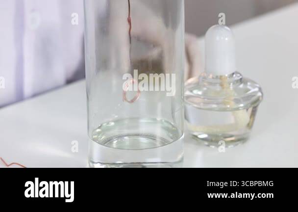 Copper wire oxidizes in acetone-filled bottle Stock Video Footage - Alamy