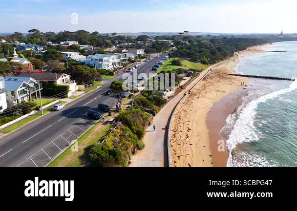 Aerial footage captures a scenic coastal road alongside Point Lonsdale ...