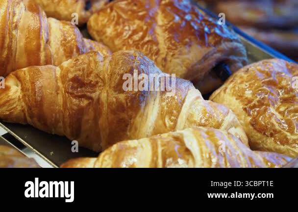 Enjoy delicious croissants straight from the oven at a nearby bakery Stock Video Footage - Alamy