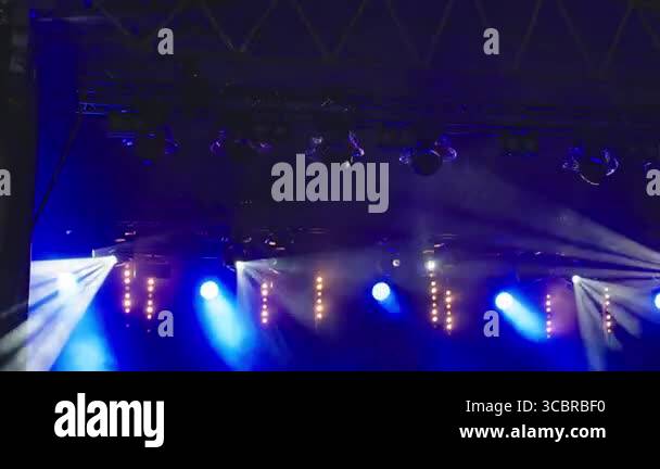 Stage with bright concert lighting, spotlights and smoke effects ...