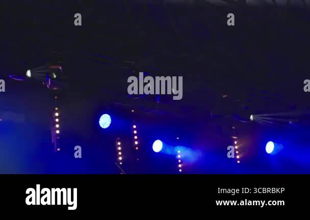 Stage with bright concert lighting, spotlights and smoke effects ...