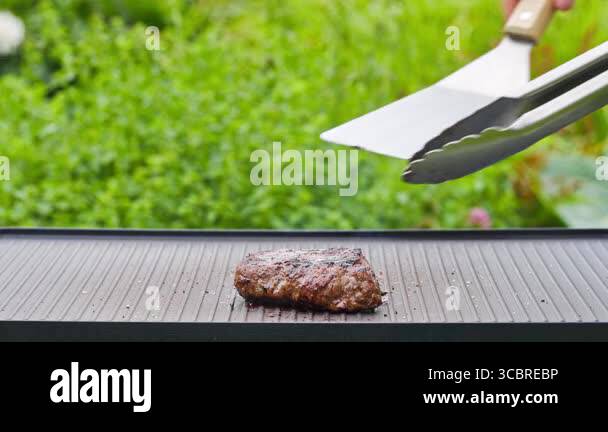 outdoor cooking. cook preparing fresh beef fillet mignon steak with ...