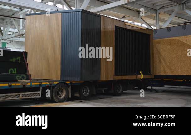 Modern prefabricated tiny house module is transported on a flatbed ...