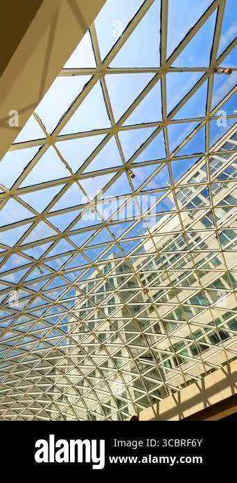 Geometric ceiling in modern design. Bright blue sky through a geometric ...