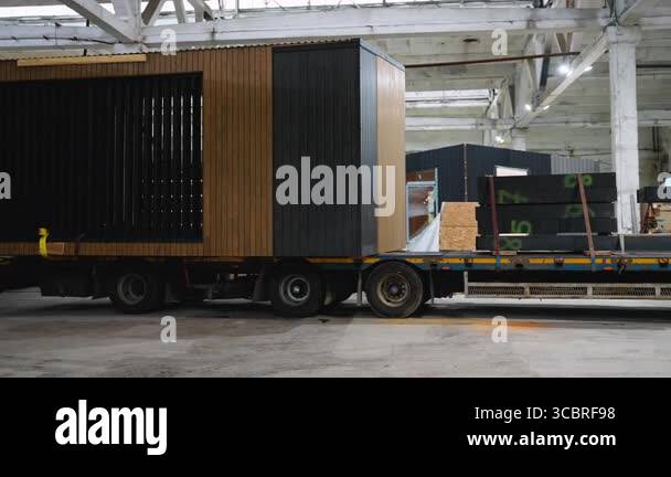 Prefabricated modular tiny house smoothly gliding on flatbed truck ...