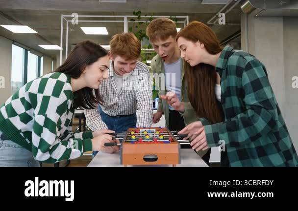 Caucasian teenage classmates competing intensely while playing table ...