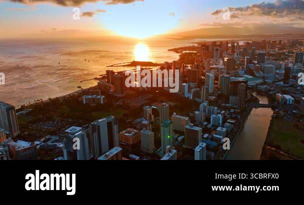 Soft orange light of sunset covering the cityscape of Honolulu, Hawaii ...