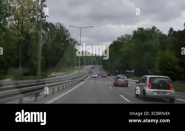 POV highway drive through green forest on a cloudy day. Watch calm ...
