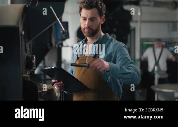 Caucasian man check coffee roasted aroma beans roaster machine ...