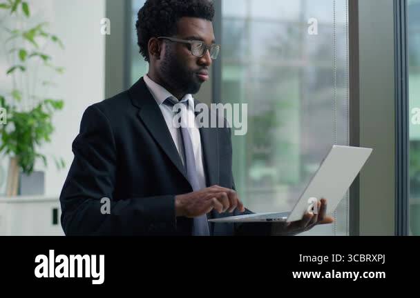 African American businessman male business man in office looking out ...
