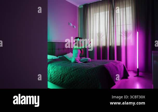 Engaging in virtual reality experience in modern bedroom setting at ...