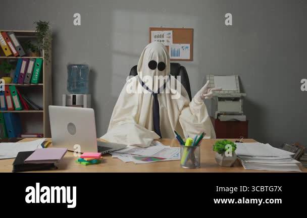 Person dressed as ghost day at work. Halloween businessman ghost in ...