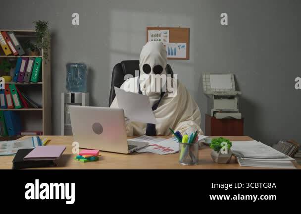 Person dressed as ghost day at work. Halloween businessman ghost in ...