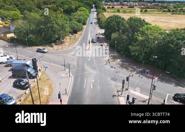 Aerial Static Low Angle Four Way Junction Surrounded By Trees In Summer ...