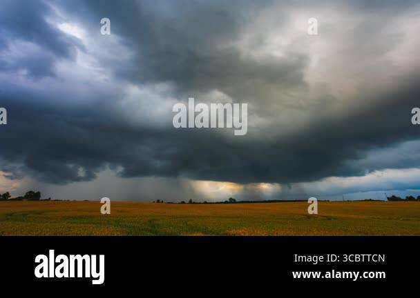 Time lapse of supercell storm rolling through the fields in Lithuania, dark storm clouds Stock ...