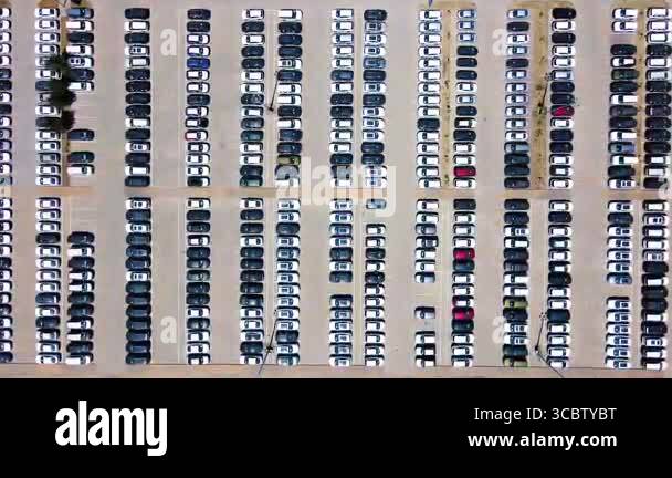 Straight rows of new cars in a parking lot. Electric vehicle. View from ...