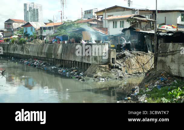 Philippine slum poor river people cooking food garbage waste shanty ...