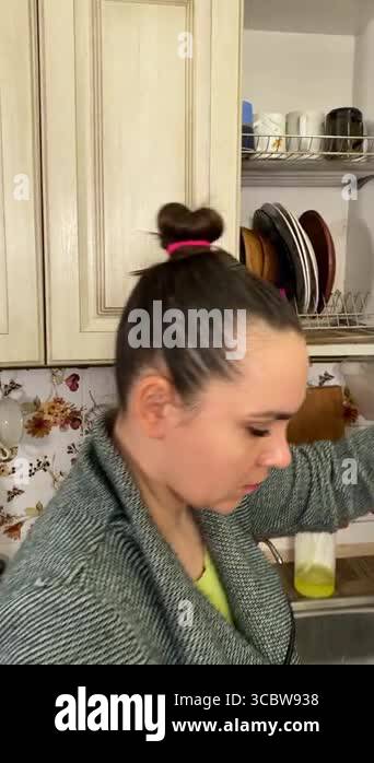 Young woman doing household chores at home, staying productive and ...