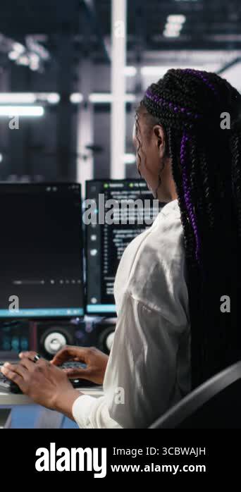 Vertical video Data center manager checking work done by admins using deep learning to analyze ...