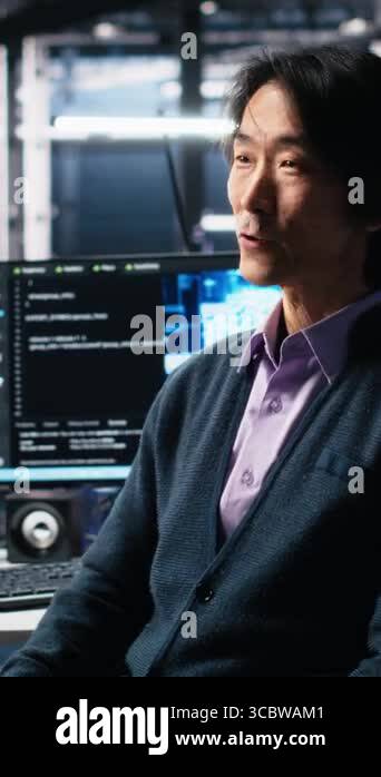 Vertical video Data center admin waving hand, filming presentation tour, showcasing mainframes ...