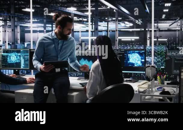 Data center engineering team members collaborating on neural network software development ...