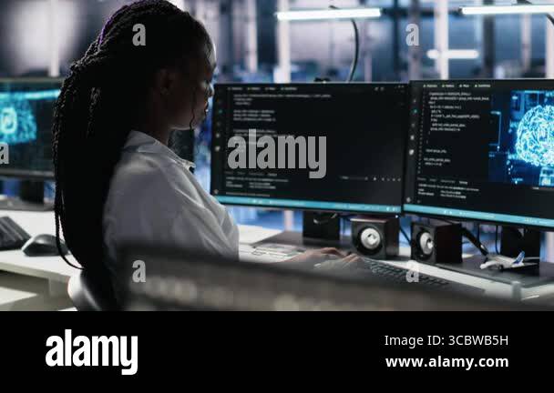 Data center system administrator working on neural network software development. African ...