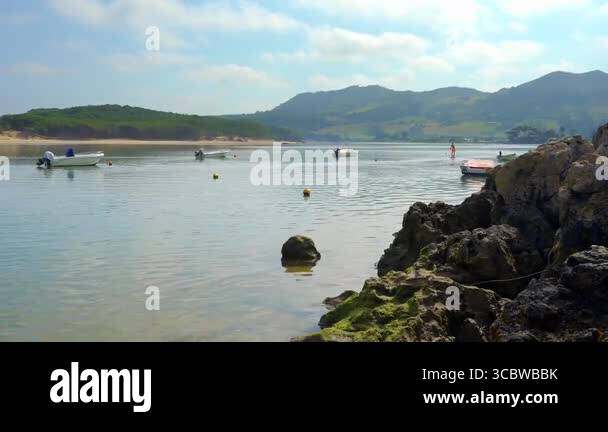 Small boats anchored in the Mogro estuary in northern Spain, Cantabria ...