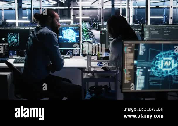 Data center admin teaching intern to monitor neural network using AI. IT expert and african ...