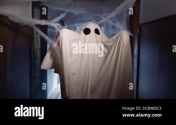 Halloween. white boo scary ghost in old corridor with cobweb at night ...