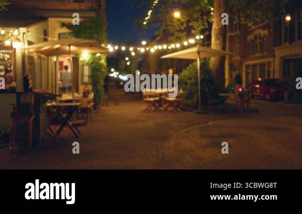 European city street scene with outdoor terrace featuring blurred ...