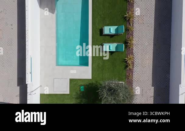 Luxury villa parasol gradually opening above turquoise pool with ...