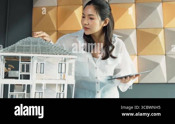 Beautiful project manager using tablet check house model. Portrait of architect engineer inspect ...