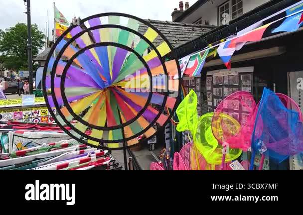 Vibrant wind wheel spinning at a market stall Stock Video Footage - Alamy