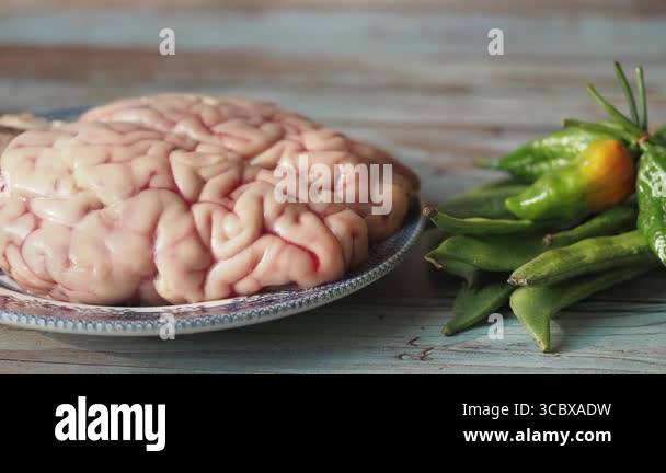 Creative dish with animal brain and veggies arranged artfully Stock ...